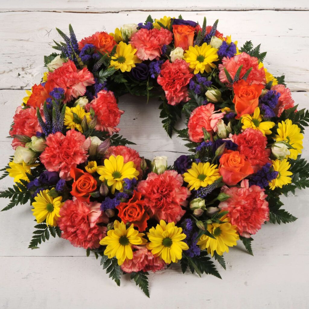Colourful Open Round Funeral Wreath | Homeland Florists