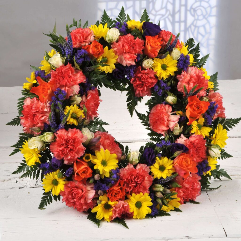 Colourful Open Round Funeral Wreath | Homeland Florists